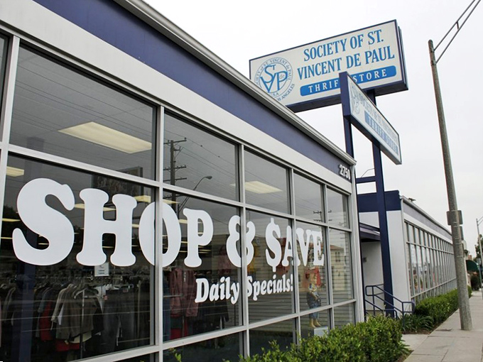The blue and white storefront promises "Shop & Save" &ndash; not just a slogan but a sacred covenant between you and your wallet.