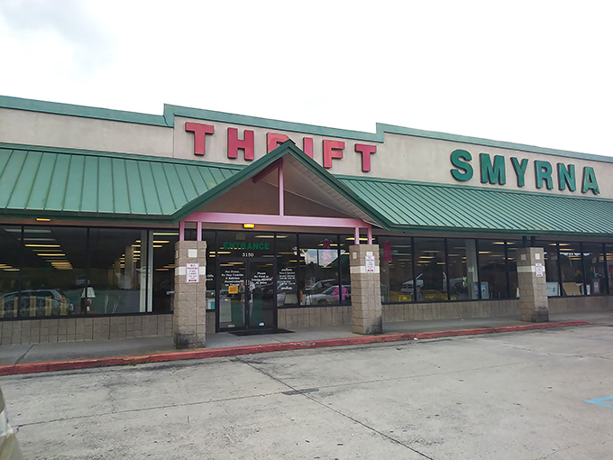 The iconic green-roofed Smyrna Thrift Store stands like a treasure chest waiting to be opened, its bold red and green signage promising adventures in secondhand shopping.