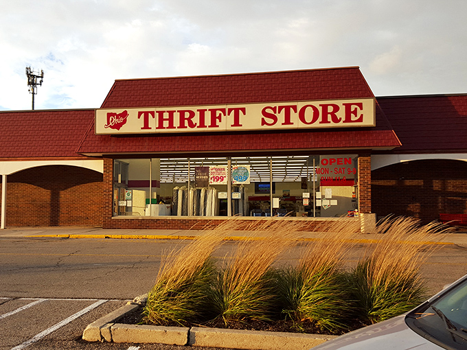 The iconic red-roofed Ohio Thrift Store stands like a treasure chest waiting to be opened, promising adventures in bargain hunting behind its modest facade.