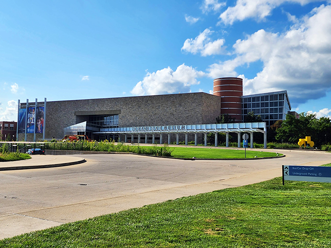The limestone fa&ccedil;ade of the Indiana State Museum stands proudly against a blue sky, its modern design blending seamlessly with Indiana's geological heritage.