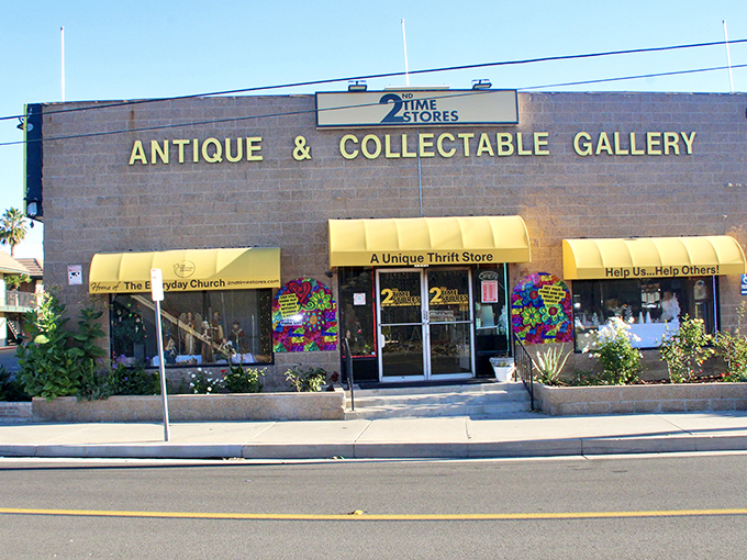 The stone facade and bright yellow awnings of 2nd Time Store stand like a beacon for treasure hunters in Tustin, promising adventures in secondhand shopping.