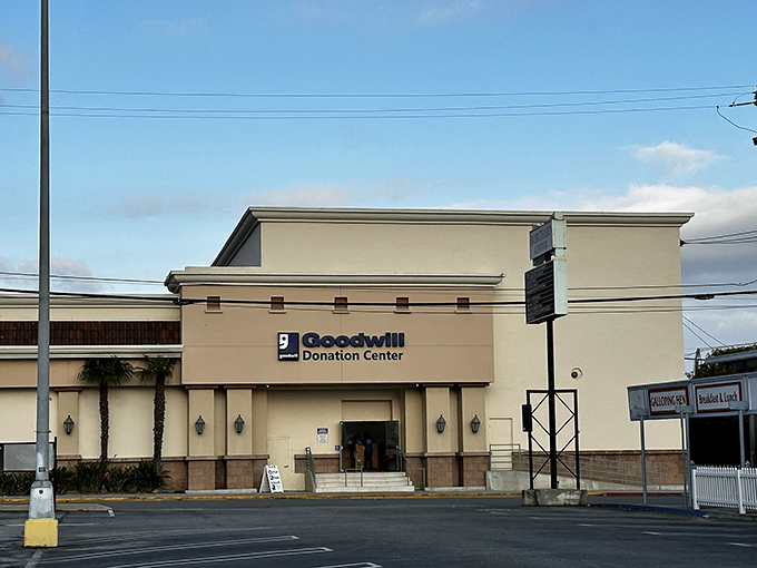 The Spanish-style façade of Ventura's Goodwill welcomes treasure hunters with palm-fringed promise and that iconic blue smile logo.