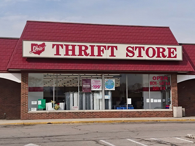 The iconic red roof and bold signage of Ohio Thrift Store beckons bargain hunters like a retail lighthouse guiding ships to treasure-filled shores.