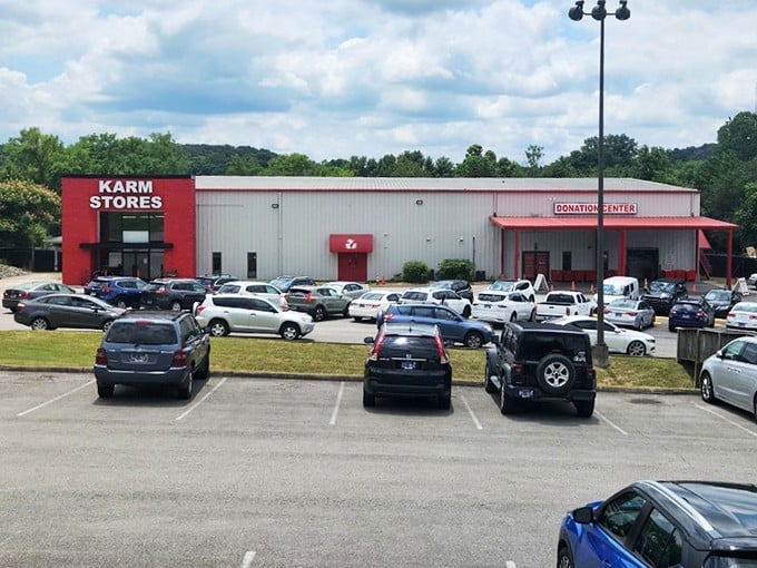 The iconic red entrance of KARM Stores stands like a beacon for treasure hunters, promising adventures in secondhand paradise under Tennessee's blue skies.
