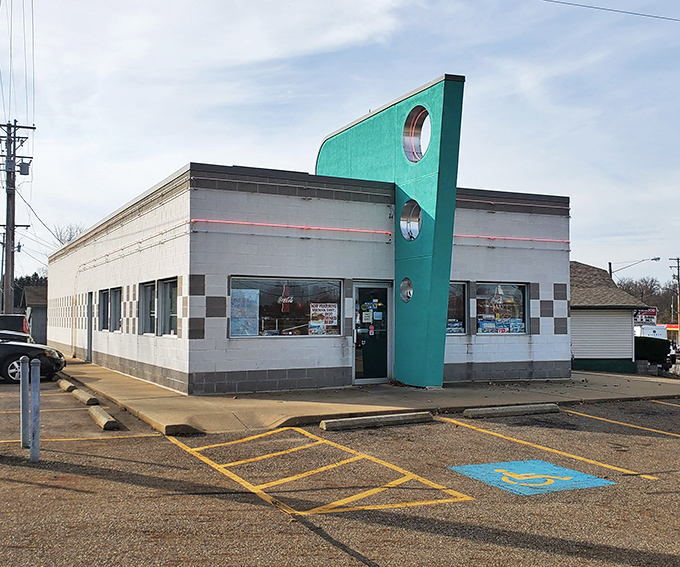 That iconic turquoise fin jutting skyward isn't just architectural flair&mdash;it's a beacon calling hungry travelers to a genuine slice of Americana in Alliance.