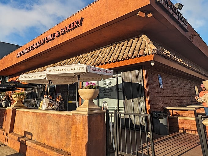 The terracotta-colored building stands like a culinary lighthouse on Lincoln Boulevard, its "As Italian as it gets!" umbrellas promising authentic delights within.