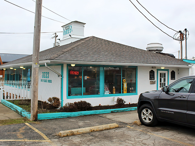 The turquoise trim against crisp white siding isn't just eye-catching—it's a beacon for hungry travelers promising authentic 50s diner magic inside.
