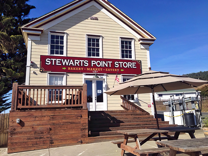 The iconic Stewarts Point Store stands proudly against the California sky, its weathered wooden steps promising culinary treasures within. A coastal landmark worth the winding drive.