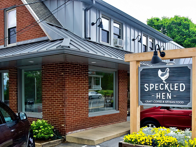 The unassuming brick exterior of Speckled Hen hides culinary treasures within. That wooden sign promises craft coffee and artisan food&mdash;spoiler alert: it delivers both spectacularly.