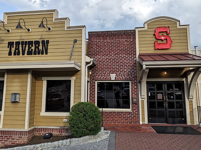 The iconic facade of Silver Spring Mining Company beckons hungry travelers with its distinctive "TAVERN" sign and bold red "S" logo, promising comfort and satisfaction within.