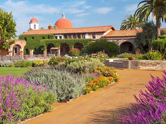 The mission's central courtyard feels like stepping into a painting—terra cotta, emerald ivy, and reflective pools creating California's most serene time machine.
