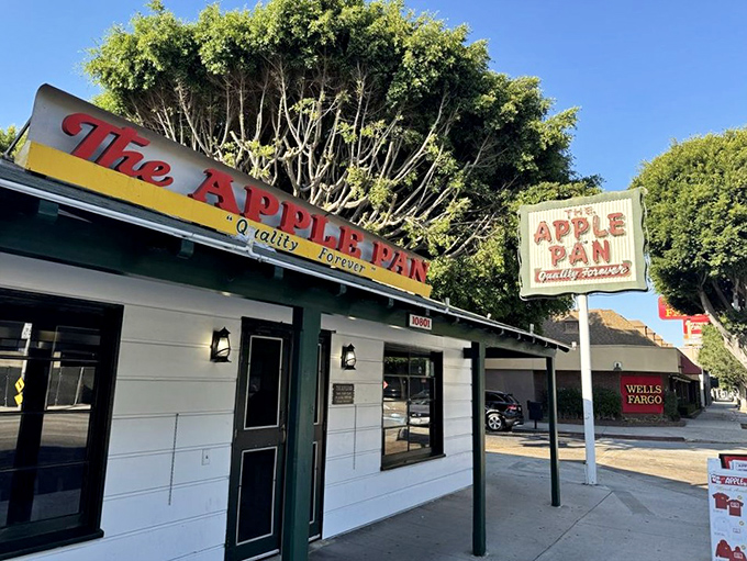 The unassuming white exterior of The Apple Pan stands like a time capsule on Pico Boulevard, its vintage sign promising "Quality Forever" &ndash; a bold claim they've been backing up since 1947.