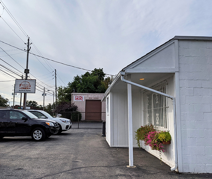 The unassuming white exterior of Fred's Diner proves once again that culinary treasures often hide in plain sight. Those flower boxes are your first clue to the warmth waiting inside.
