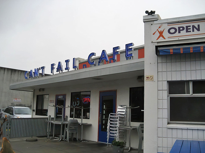 The iconic blue signage of Rudy's Can't Fail Cafe beckons hungry diners with its promise of comfort food and punk rock attitude.