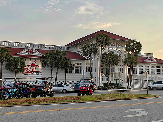 The Crab Trap stands proudly against the Florida sky, its red roof and iconic crab logo beckoning seafood lovers like a lighthouse for hungry souls.