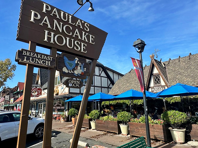 The iconic wooden sign beckons like a lighthouse for the breakfast-deprived. Paula's Danish-inspired architecture promises pancake nirvana in Solvang's storybook setting.