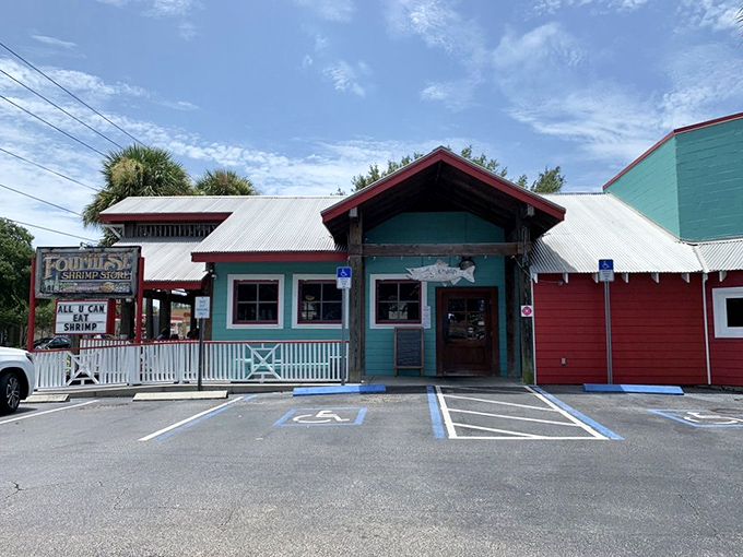 The aqua and red exterior of Fourth Street Shrimp Store stands as a beacon of seafood salvation on St. Petersburg's busy thoroughfare.