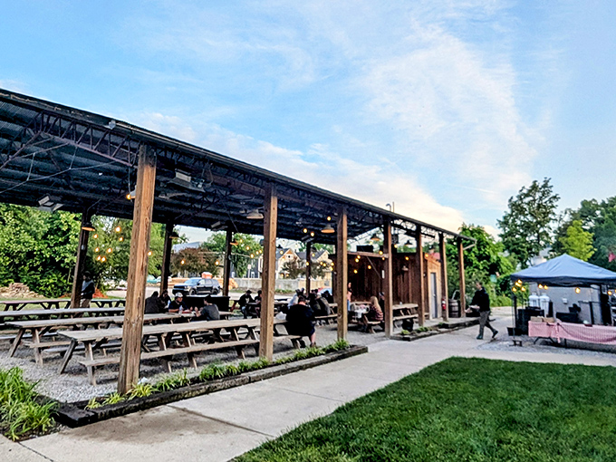 The outdoor patio at Eli's BBQ is where summer dreams come true&mdash;string lights, wooden beams, and wildflowers creating the perfect backdrop for smoky indulgence. 