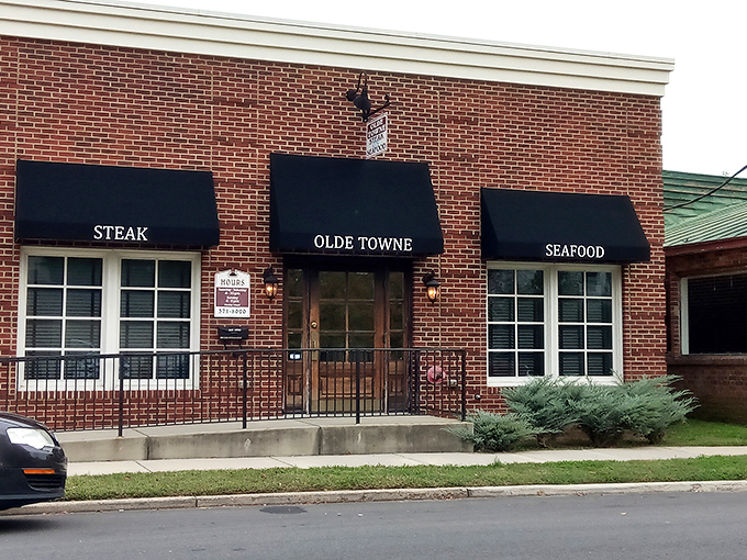 The unassuming brick exterior of Olde Towne Steak & Seafood might not stop traffic, but locals know those black awnings mark the entrance to flavor paradise.