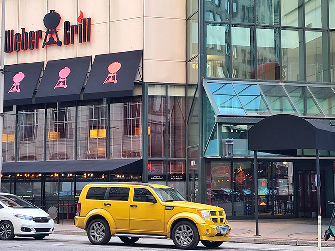 The iconic Weber kettle grill silhouettes stand guard above the entrance like sentinels of sizzle, promising smoky delights within this downtown Indy landmark.