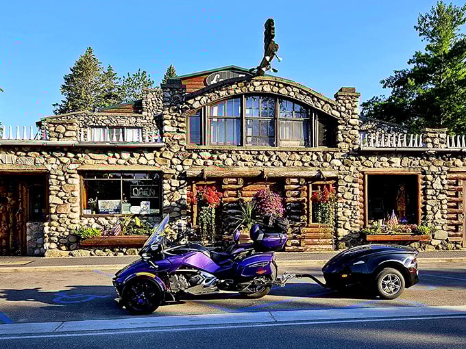 The stone fortress of Legs Inn stands proudly at the end of Michigan's Tunnel of Trees, its quirky roofline adorned with cast iron stove legs that give this culinary landmark its name.