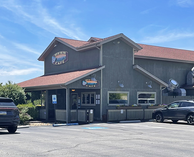 The unassuming exterior of Out of the Fire Cafe hides culinary treasures within, like finding a Michelin-worthy meal in a cozy mountain cabin.