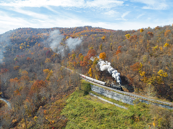 Steam meets autumn splendor as the locomotive winds through Maryland's mountains. Nature's paintbrush has transformed these hills into a masterpiece of amber and gold.