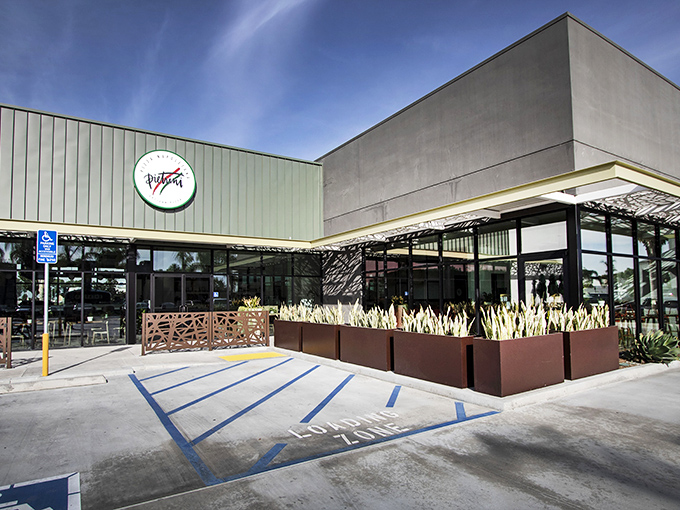 The unassuming exterior of Pietrini Pizza Napoletana proves once again that California's best culinary treasures often hide in plain sight, surrounded by pampas grass and promise.