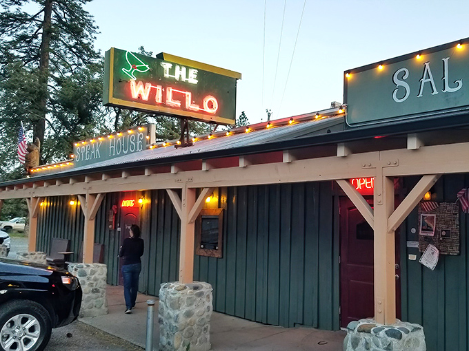 The neon glow of Willo's sign against the twilight sky is like a beacon for hungry travelers. Pure roadside Americana that promises carnivorous delights within.