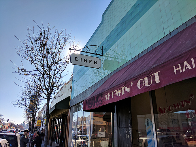 A simple sign reading "DINER" against turquoise tiles tells you everything you need to know&mdash;culinary treasures often hide behind the most unassuming facades.