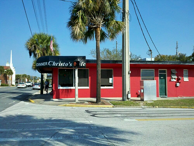 The unmistakable red exterior of Christo's Caf&eacute; stands out like a culinary lighthouse, beckoning hungry travelers with promises of breakfast bliss in Orlando.