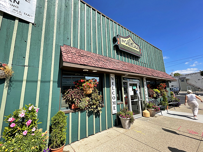 The unassuming green exterior of Northside Grill welcomes hungry patrons with colorful flower pots and a simple "WELCOME" sign—proof that culinary treasures often hide in plain sight.