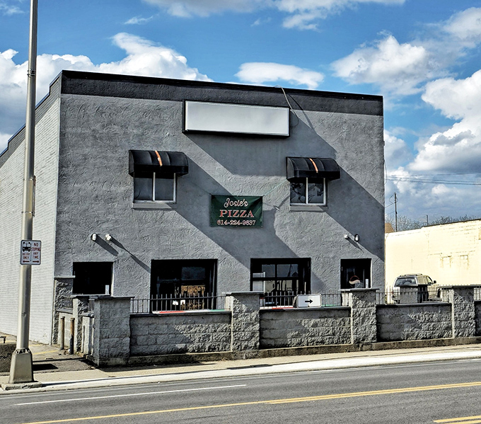 The gray fortress of flavor on West Broad Street stands proud with American flags and those inviting red umbrellas beckoning pizza pilgrims inside.
