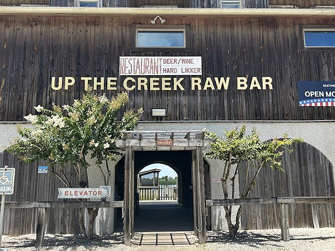 The weathered wooden exterior of Up the Creek Raw Bar stands as a testament to authentic Florida coastal charm, promising seafood treasures within.