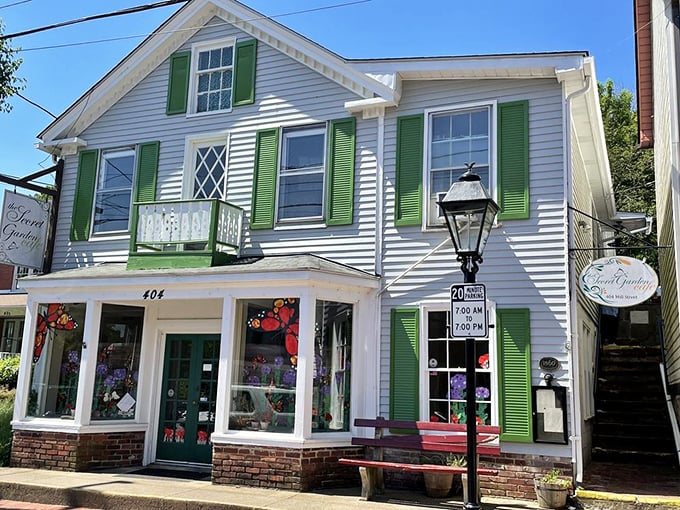 The charming white clapboard exterior with vibrant green shutters beckons like a storybook cottage, promising culinary adventures up those inviting stairs.