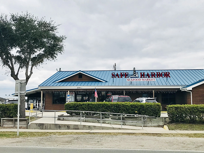 The blue-roofed sanctuary of seafood salvation stands unassumingly along Atlantic Beach's shoreline, promising treasures from the deep without an ounce of pretension.