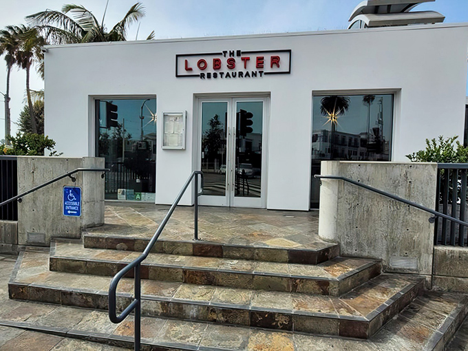 The pristine white exterior of The Lobster stands like a culinary lighthouse at the entrance to Santa Monica Pier, beckoning seafood lovers home.