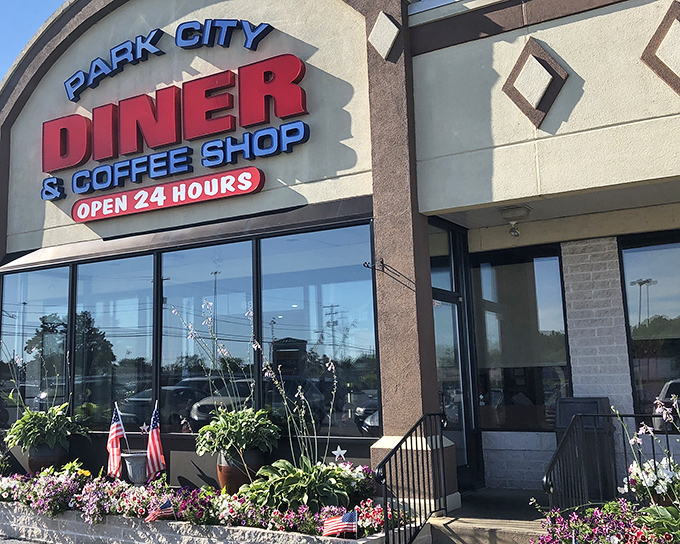 The welcoming facade of Park City Diner stands as a 24-hour beacon for hungry travelers, its flower boxes adding a touch of homey charm to this Lancaster institution.