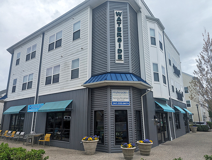 Modern meets cozy at this corner establishment, where the teal awnings and flower pots hint at the warm welcome waiting inside.