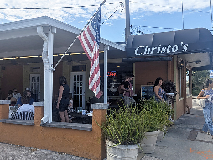 The coral-colored exterior of Christo's Caf&eacute; welcomes you with potted plants and outdoor seating&mdash;proof that culinary treasures often hide in unassuming packages.