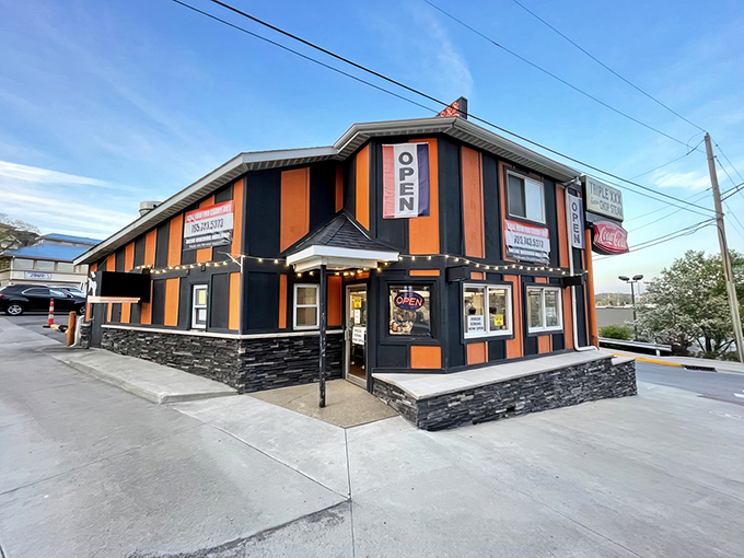 The iconic orange and black stripes of Triple XXX stand defiant against modern architecture, like a time traveler refusing to leave 1950.