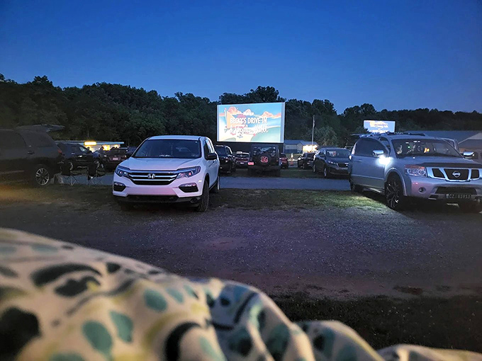 Twilight magic unfolds as cars gather beneath a Pennsylvania sky, the massive screen glowing with cinematic promise. Modern technology meets nostalgic tradition.