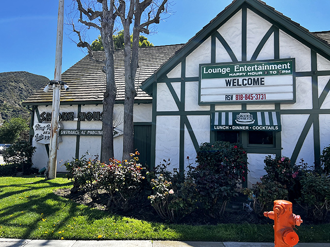 The Tudor-style exterior of The Smokehouse stands as a charming time capsule in Burbank, promising old-Hollywood glamour and garlic bread dreams inside.