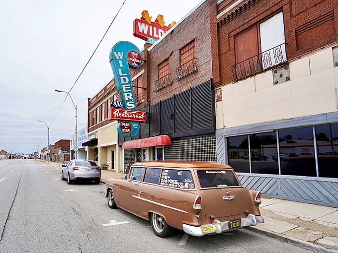 That neon sign isn't just advertising – it's a beacon of hope for hungry travelers. The vintage glow promises carnivorous delights await inside.