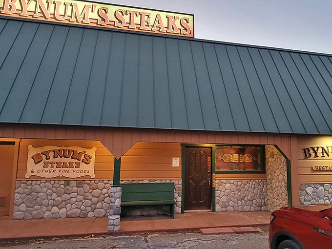 The iconic green roof and stone facade of Bynum's Steakhouse stands as a beacon for hungry travelers. No fancy frills needed when what's inside is this good.