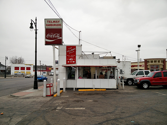 The iconic white cube of Telway stands like a time capsule on Detroit's landscape, its vintage sign beckoning burger lovers for generations.