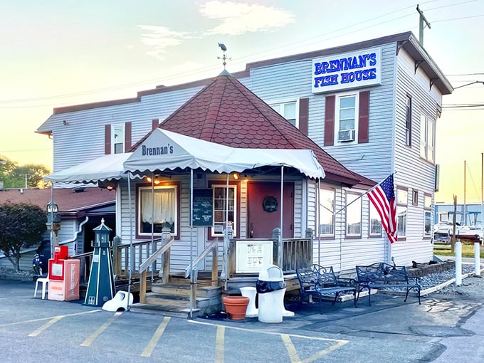 The unassuming exterior of Brennan's Fish House stands like a maritime sentinel in Grand River, complete with its iconic red-roofed turret and welcoming porch.