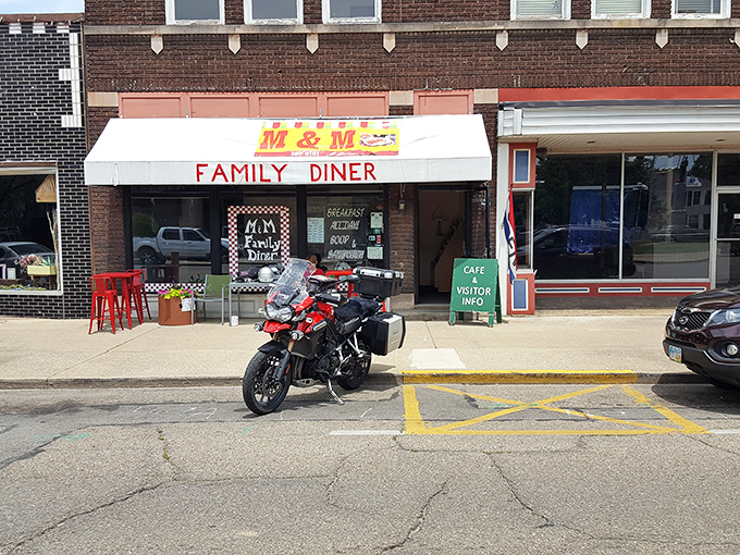 The unassuming storefront of M & M Family Diner beckons hungry travelers with its classic white awning and red lettering&mdash;proof that culinary treasures often hide in plain sight.