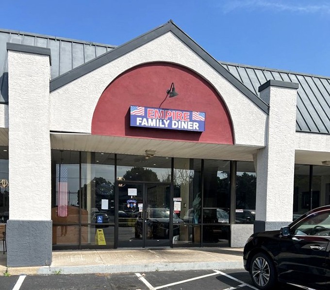 The iconic red arch of Empire Family Restaurant beckons hungry travelers like a culinary lighthouse in a sea of chain restaurants.