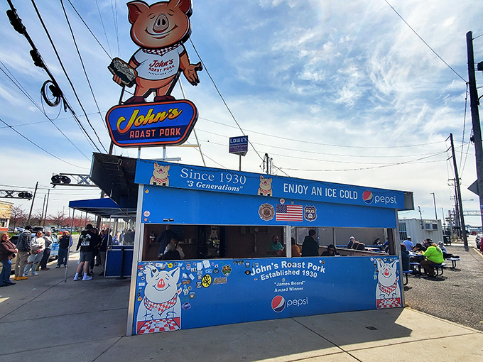 The bright blue exterior of John's Roast Pork stands out like a culinary lighthouse, guiding hungry souls to sandwich nirvana since 1930.